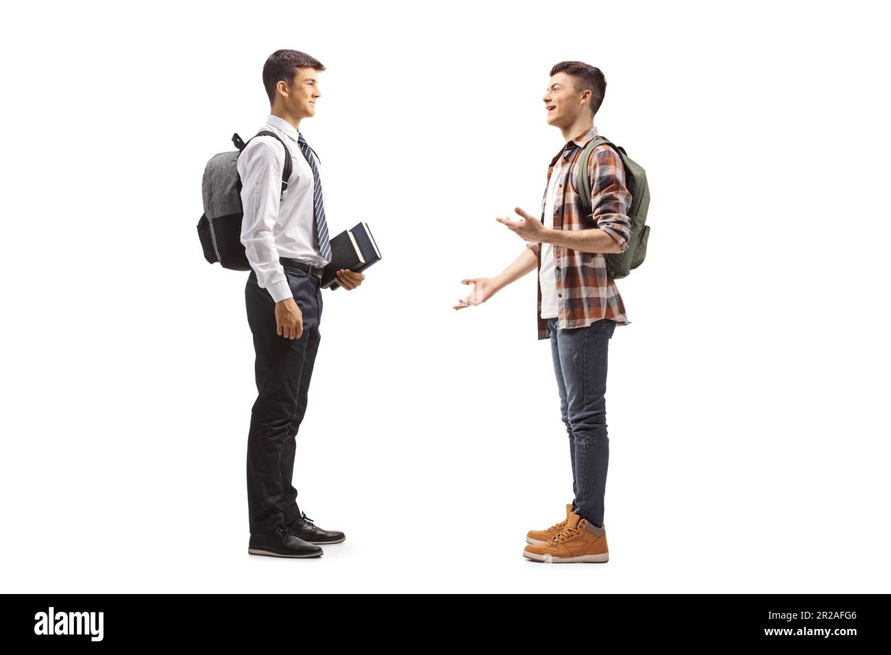 Full length profile shot of two male students having a conversation ...