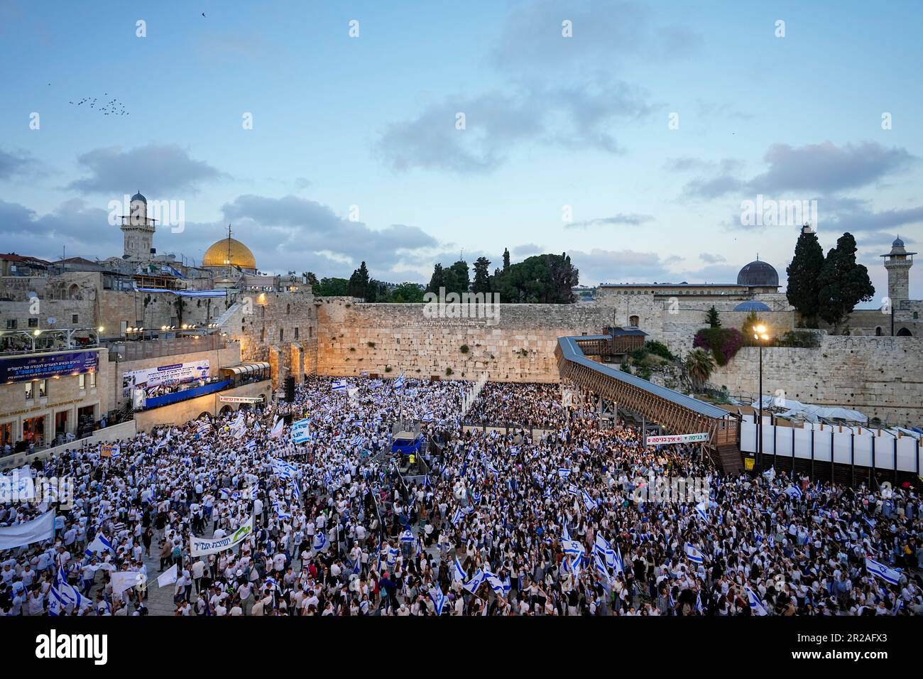 Thousands of Israelis dance and wave national flags during a march ...