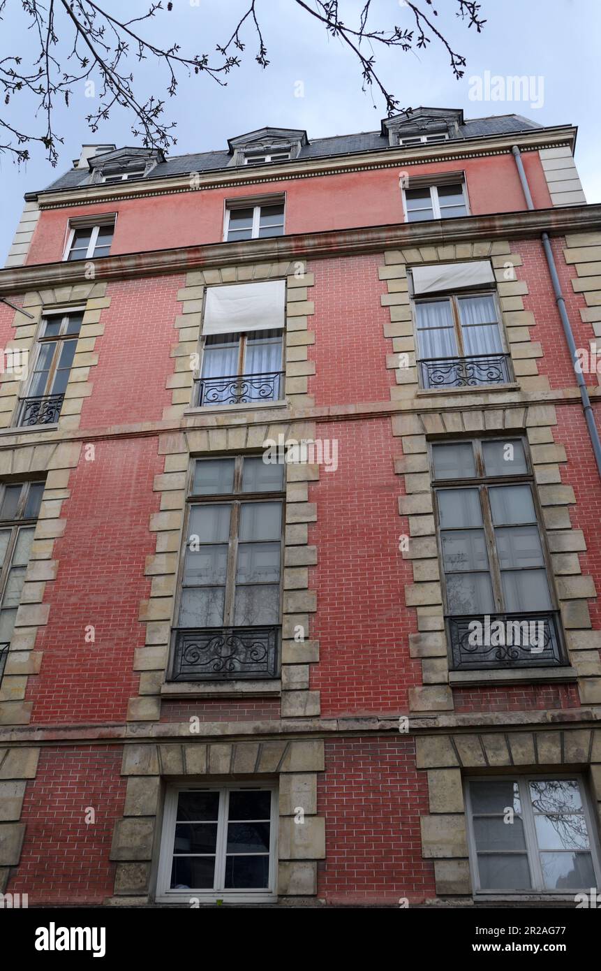 Red bricks residential building at the Marais quarter in Paris, France ...