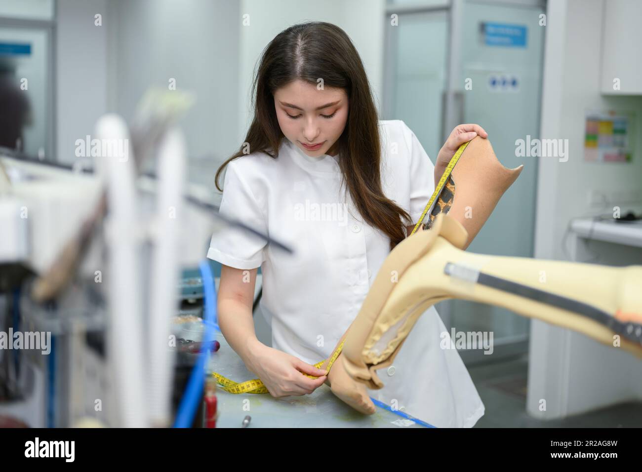 Technician holding prosthetic leg checking and working in laboratory ...