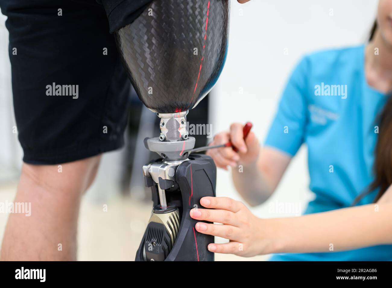 Physiotherapist adjusting prosthetic leg of patient in hospital Stock ...