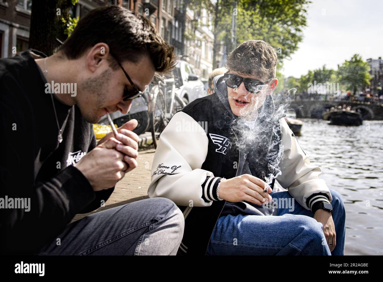 AMSTERDAM - A group of German tourists smoke a joint in the Red Light ...