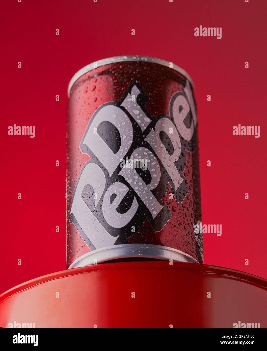 Studio image of a cold can of Dr Pepper shot on a red background ...