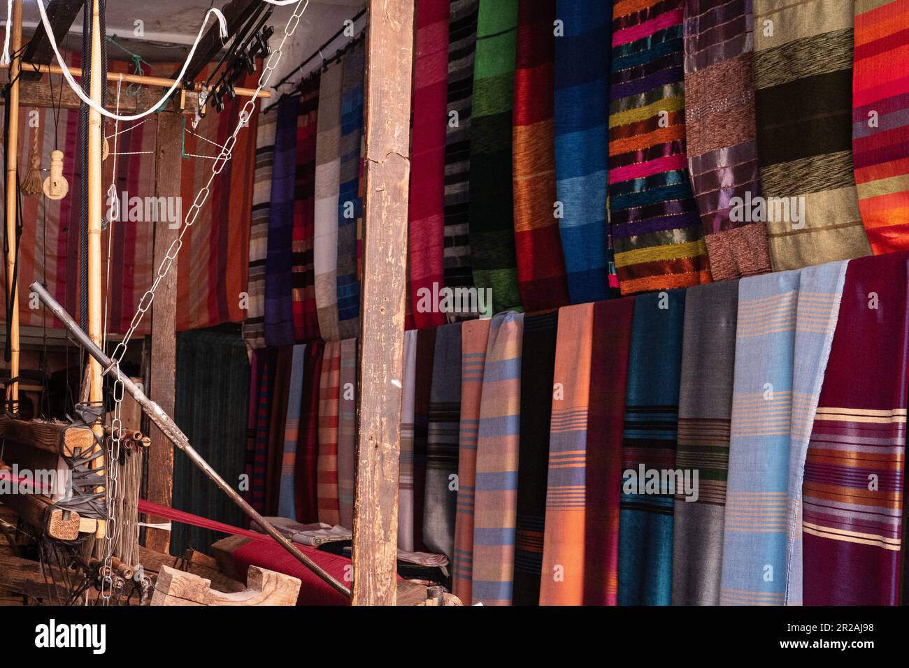 Local artisan weaving with traditional frame and creating handmade ...