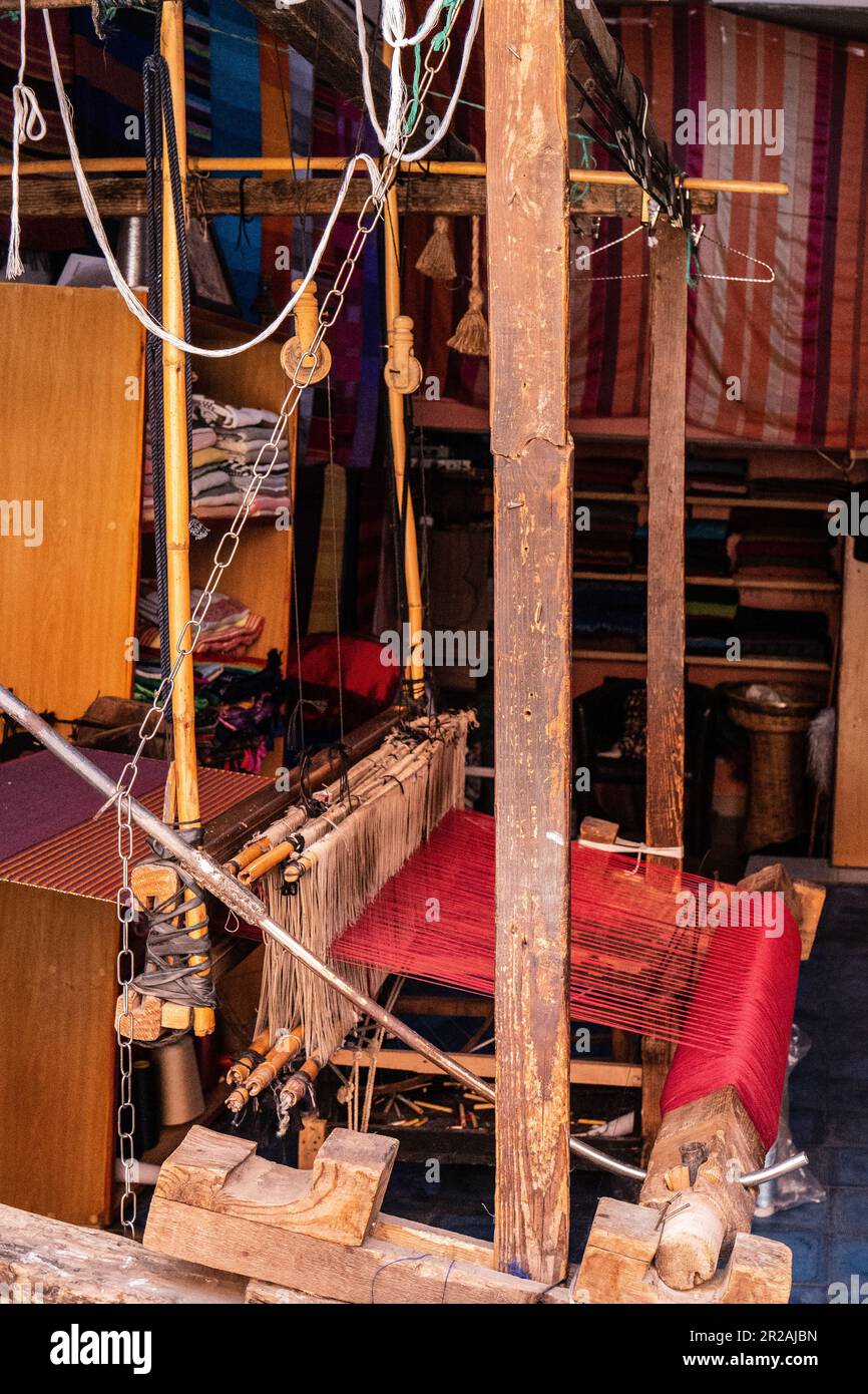 Local artisan weaving with traditional frame and creating handmade ...