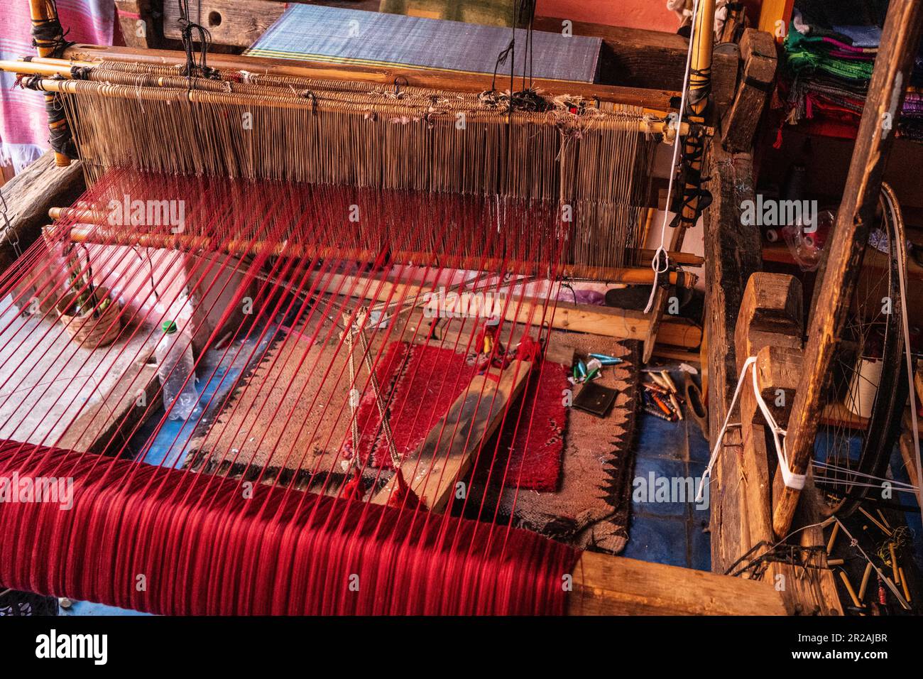 Local artisan weaving with traditional frame and creating handmade ...