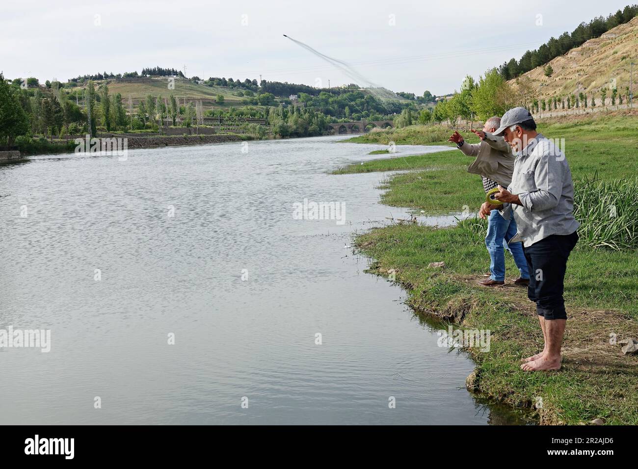 A fisherman is seen throwing his net in Tigris river. In Diyarbakir, it ...
