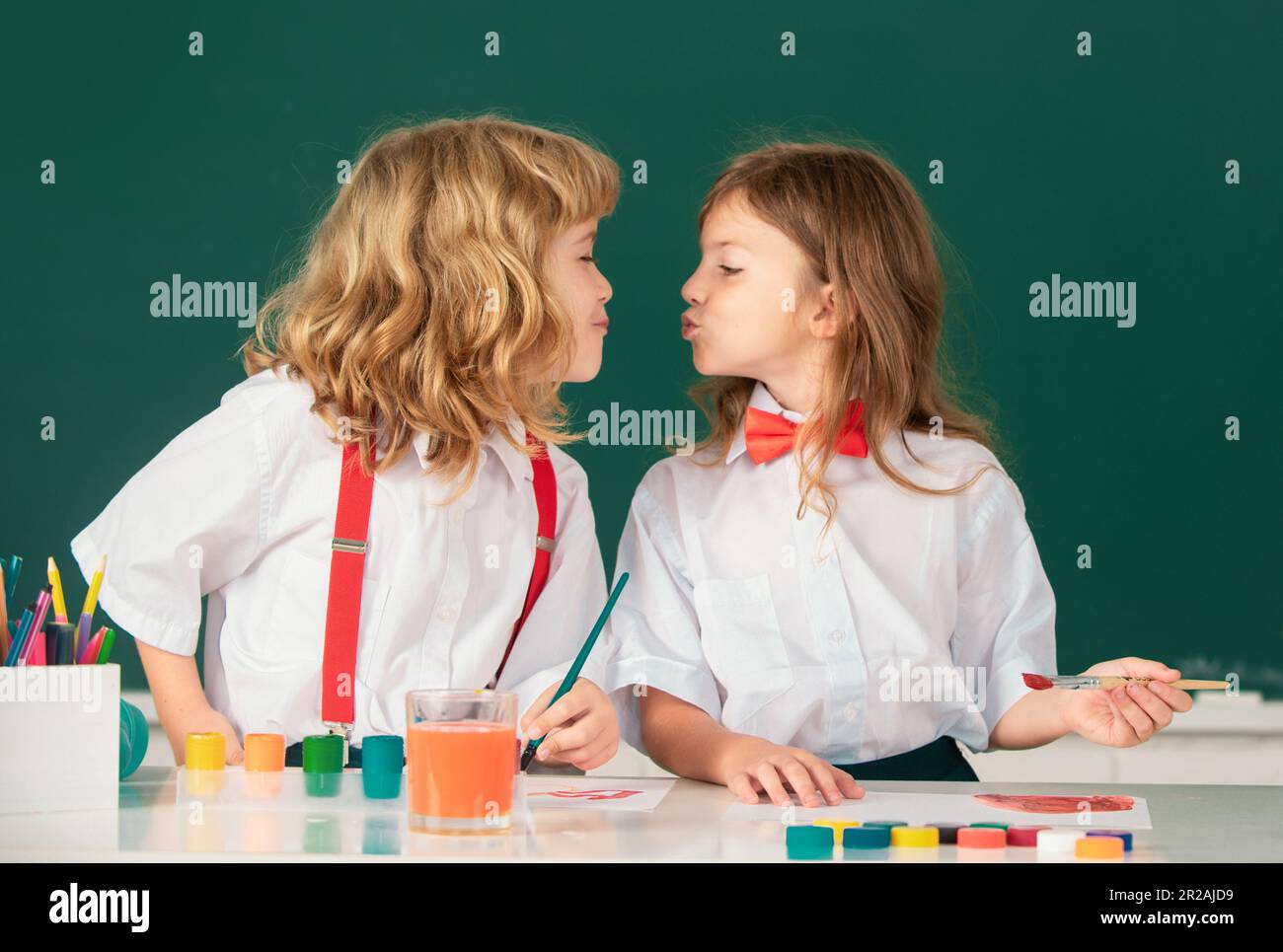 Cute school friends kids drawing and painting at school. Friendly boy ...