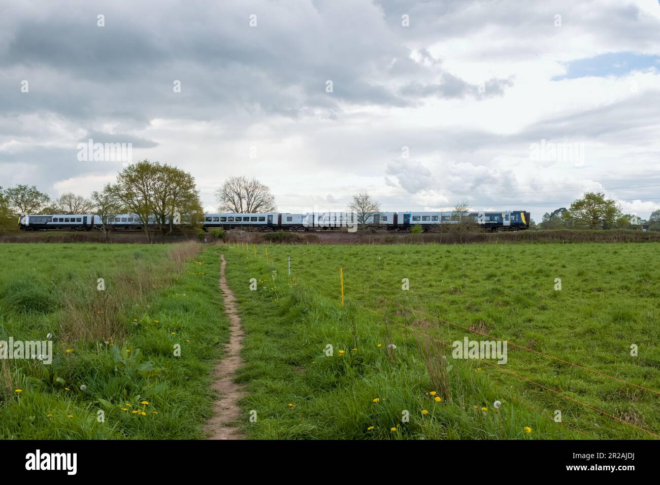 SWR train travelling through the countryside on a stormy spring day ...
