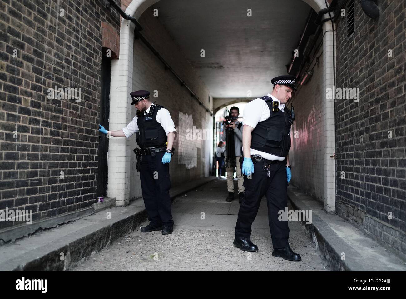 Police officers performing a weapons sweep as part of operational ...