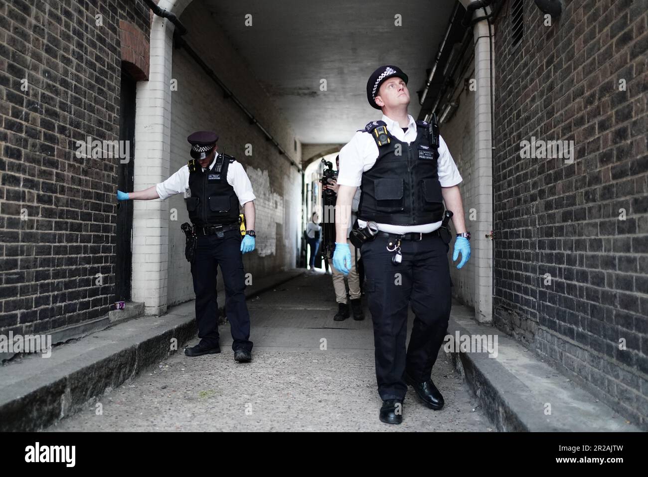 Police officers performing a weapons sweep as part of operational ...
