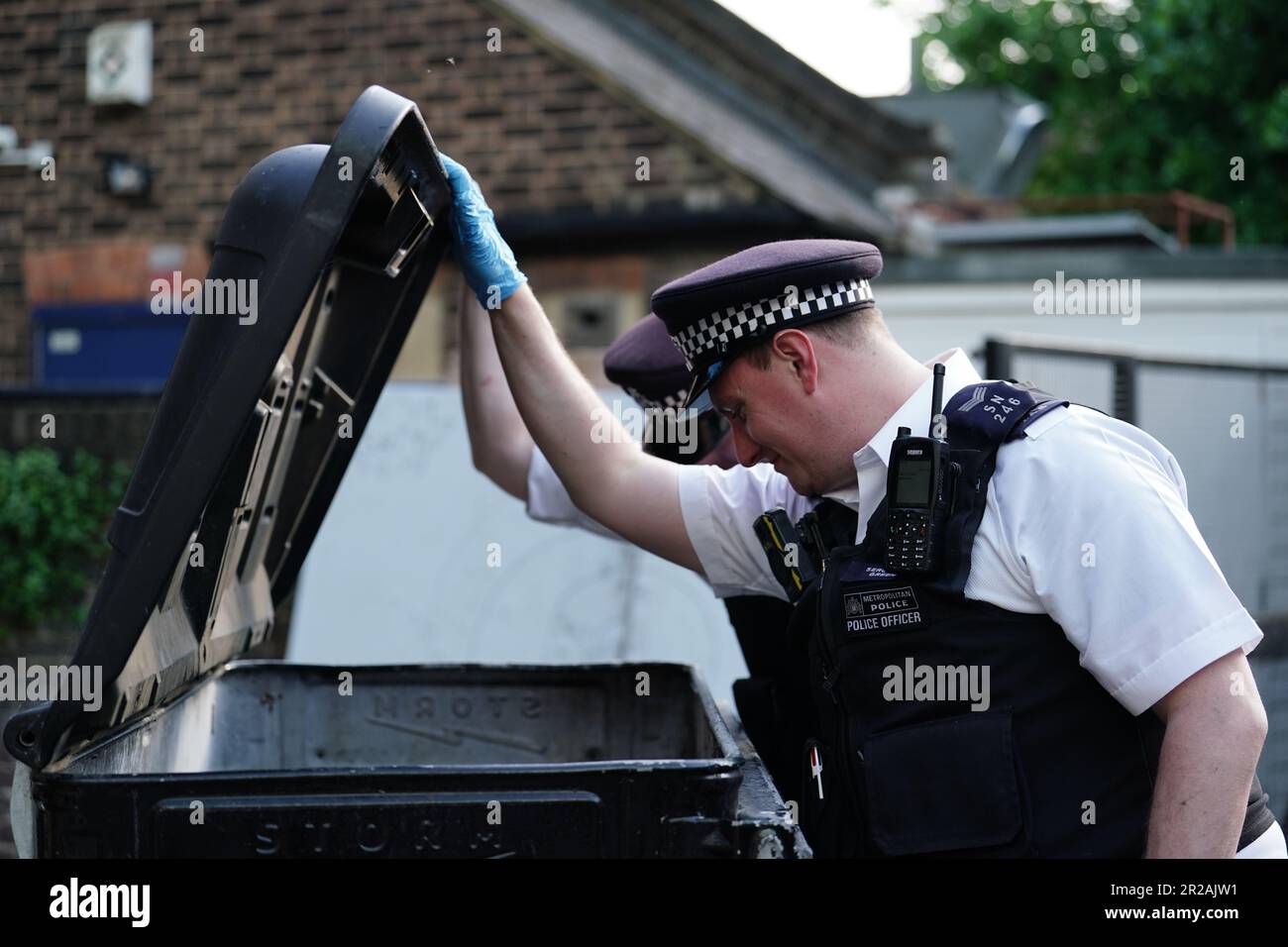 Police officers performing a weapons sweep as part of operational ...