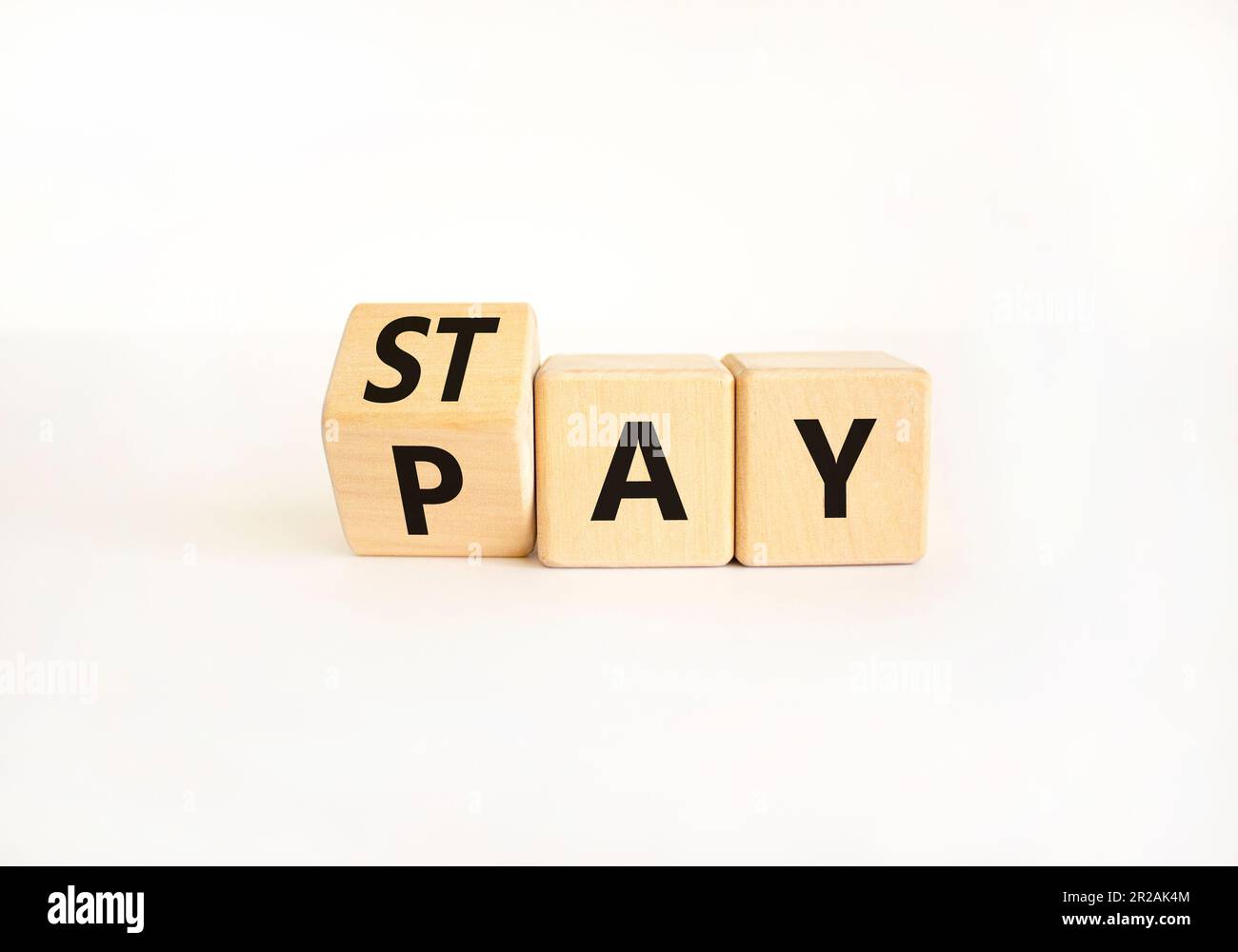 Stay and pay symbol. Businessman turns wooden cubes and changes the ...