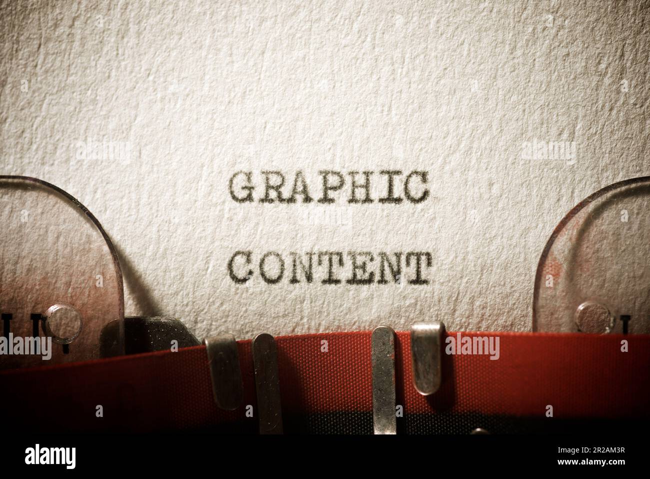 Graphic content text written with a typewriter Stock Photo - Alamy