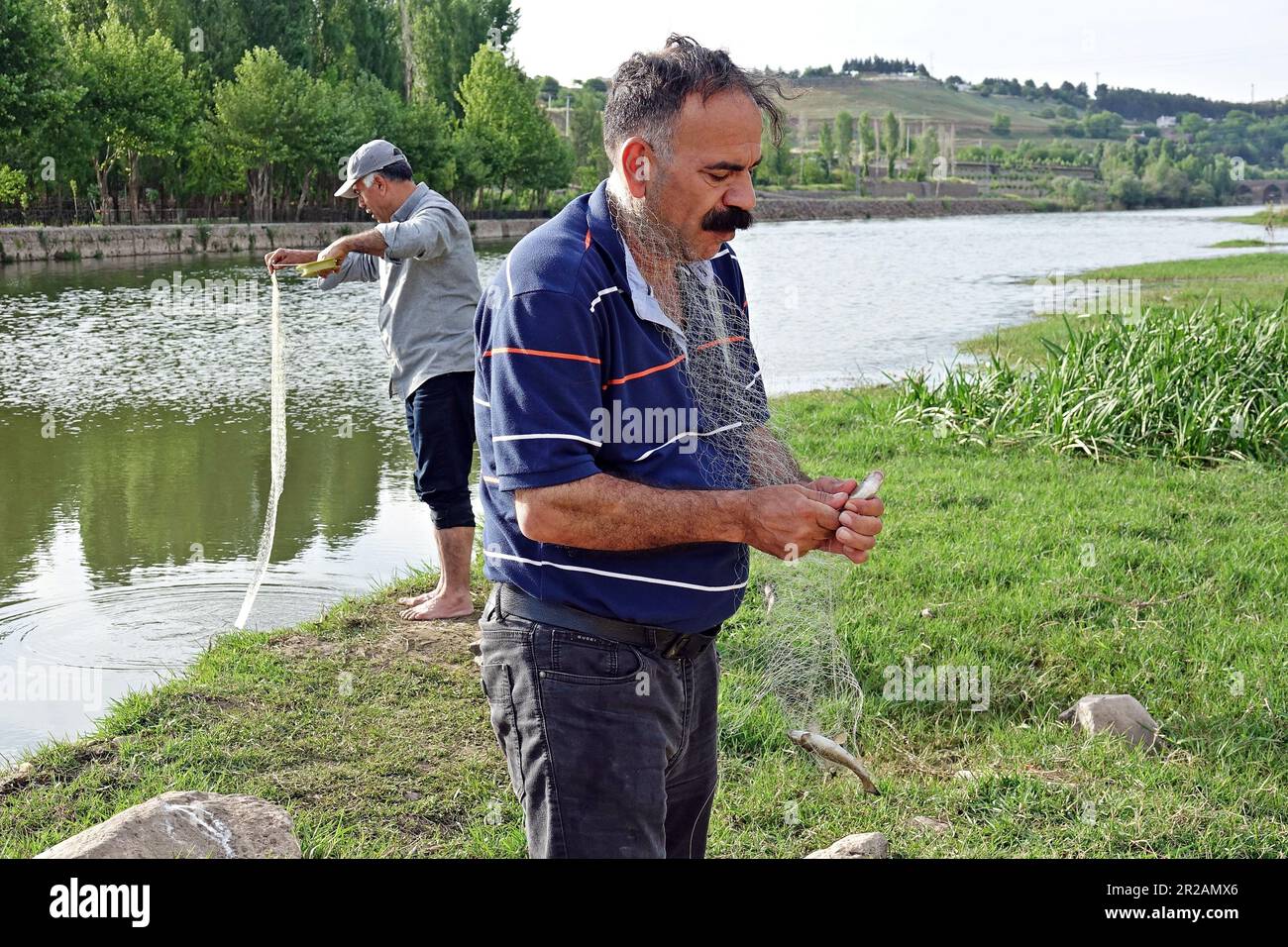 May 17, 2023, Diyarbakir, Turkey: A fisherman is seen removing fish he ...