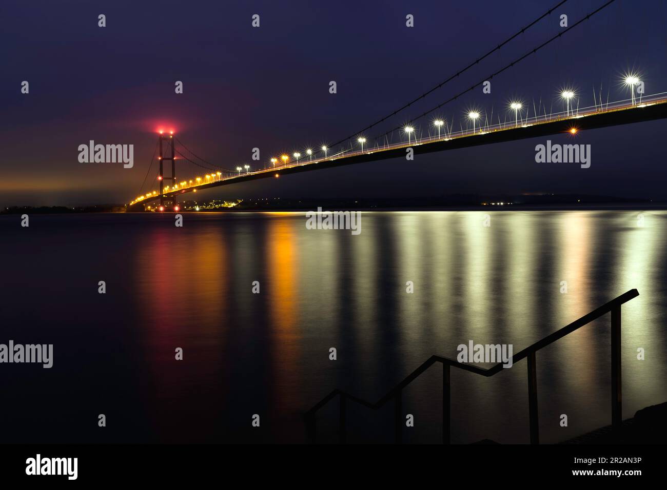 The Humber bridge lit up by bright colorful lights reflecting on the ...