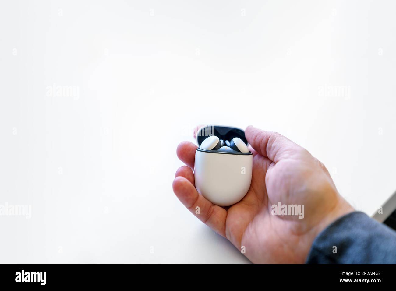 Wireless earbuds headphones in their charging case with the lid open ...