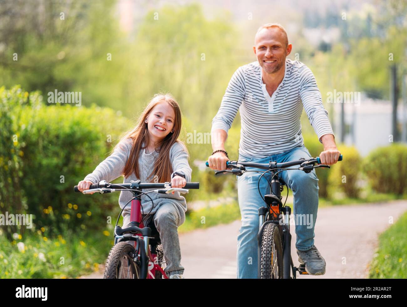 Portraits Smiling father with daughter during summer outdoor bicycle ...