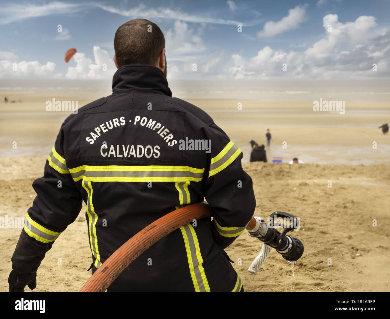 Houlgate, France May 2023. A firefighter with a hose to put out fires ...