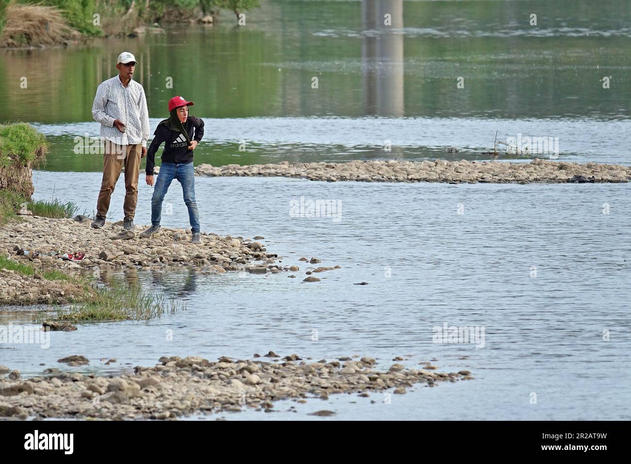 Shepherds are seen playing a game of bouncing stones on the surface of ...