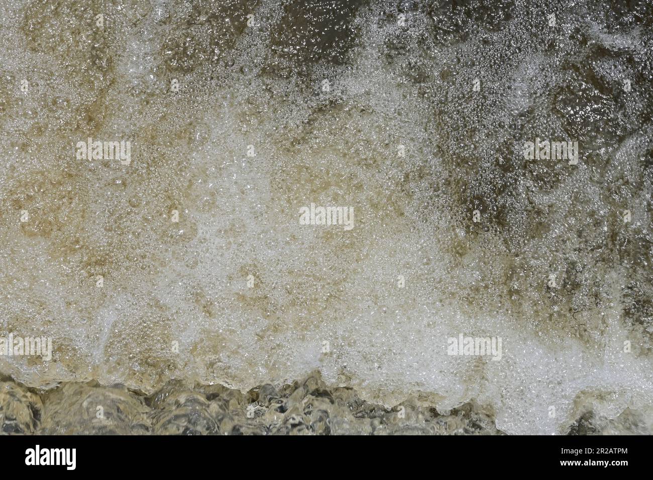 Fast flowing water making the white foams on the water surface of a ...