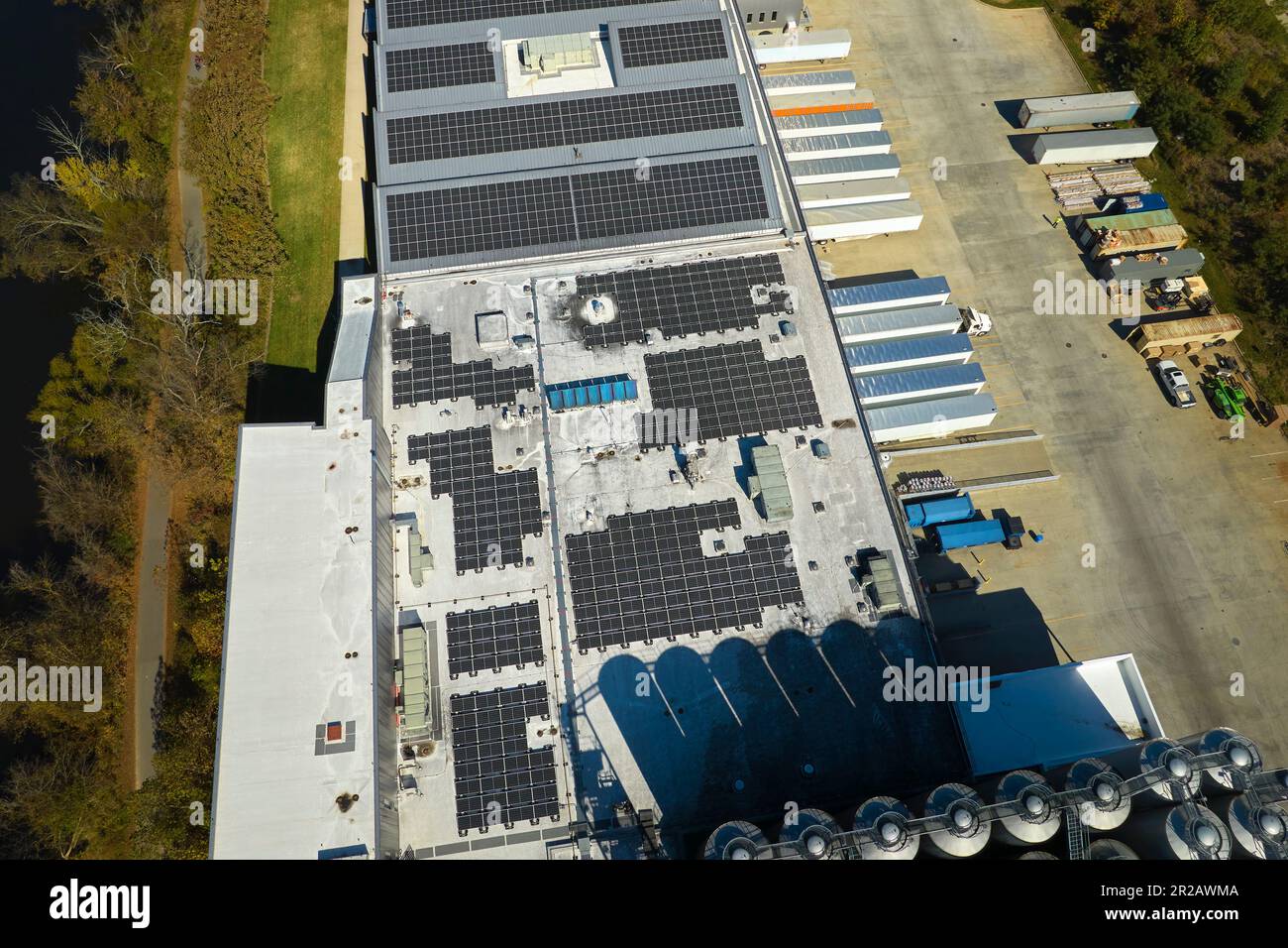 Aerial view of blue photovoltaic solar panels mounted on industrial ...
