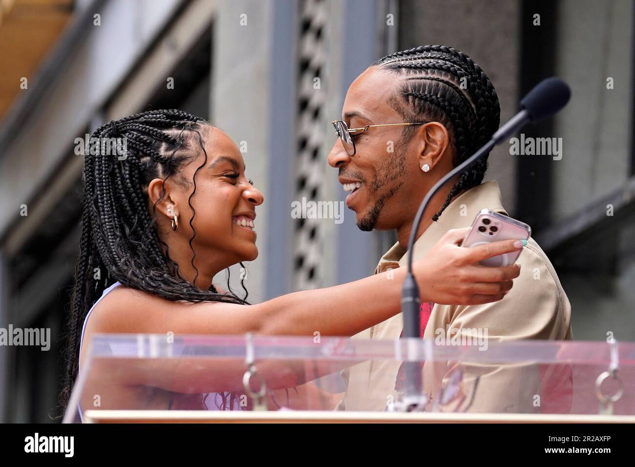 Ludacris hugs his daughter Karma during a ceremony honoring him with a ...