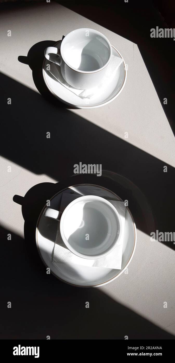 Coffee cups with shadows Stock Photo - Alamy