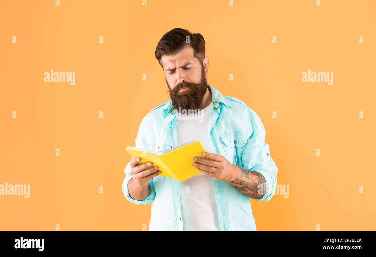 curious bearded man with planner on yellow background, daily planning Stock Photo - Alamy