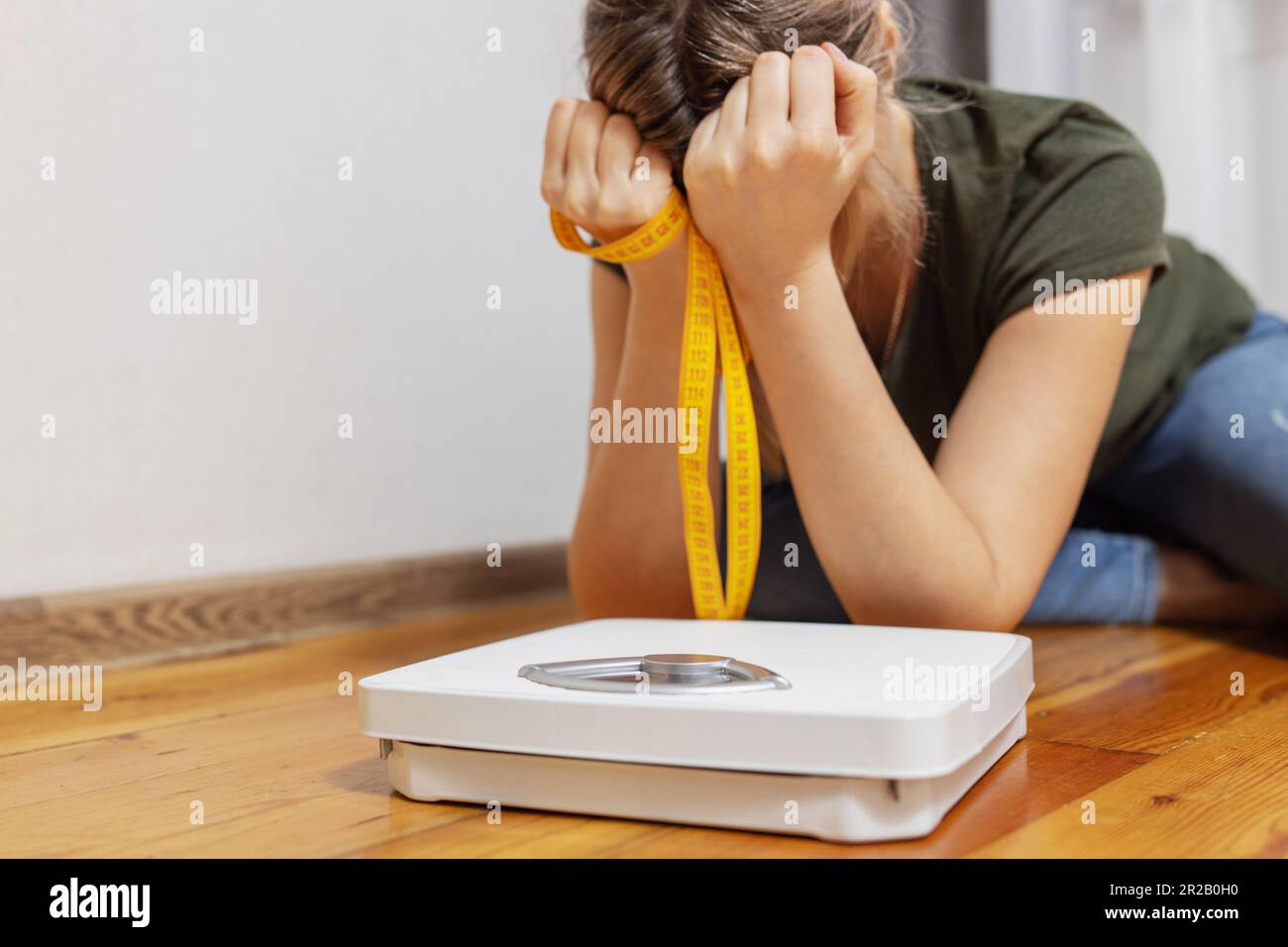 White scale and depression, upset and sad woman with measuring tape on ...