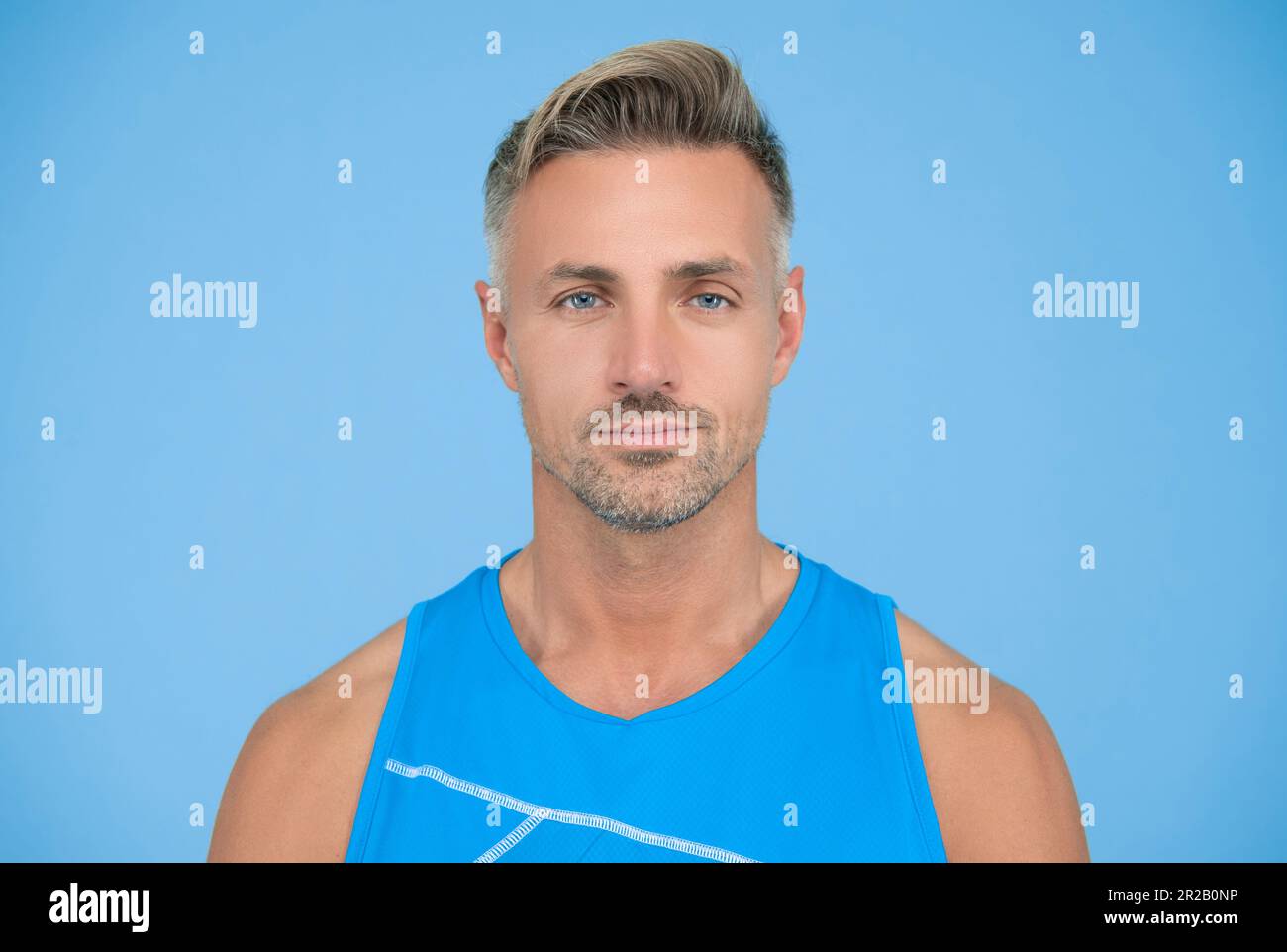 Portrait of handsome man. Grizzled man face blue background. Sportsman ...