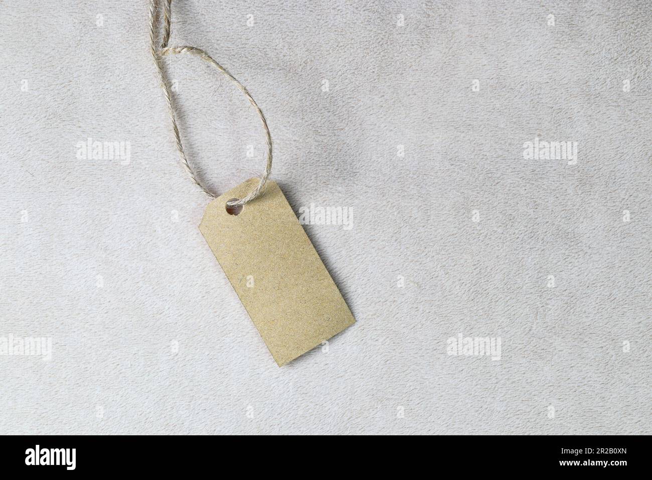 Blank tag tied with natural material string. Price tag, gift tag, sale tag, address label Stock ...