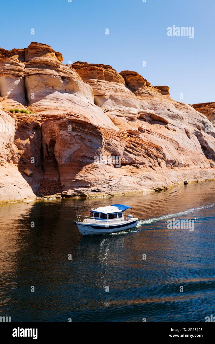 Vacationers in power boat explore Lake Powell; Glen Canyon Dam; Glen ...