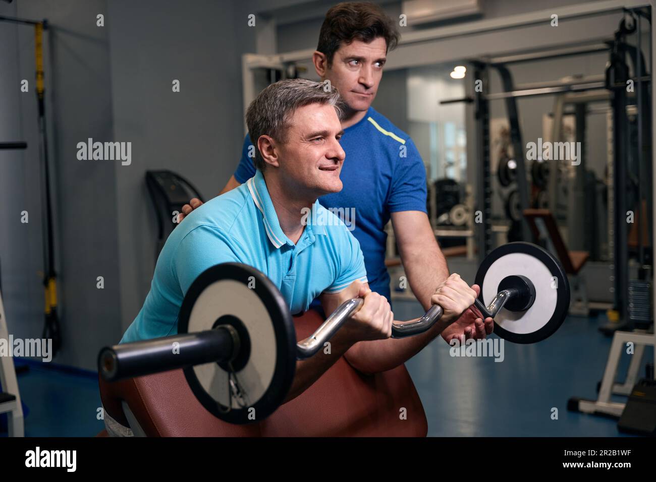 Sporty man performing bicep exercise hi-res stock photography and ...