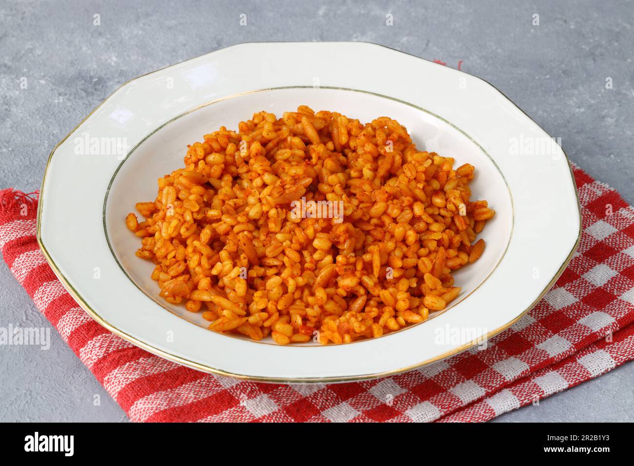Traditional turkish bulgur pilaf with tomato sause in plate (Turkish ...