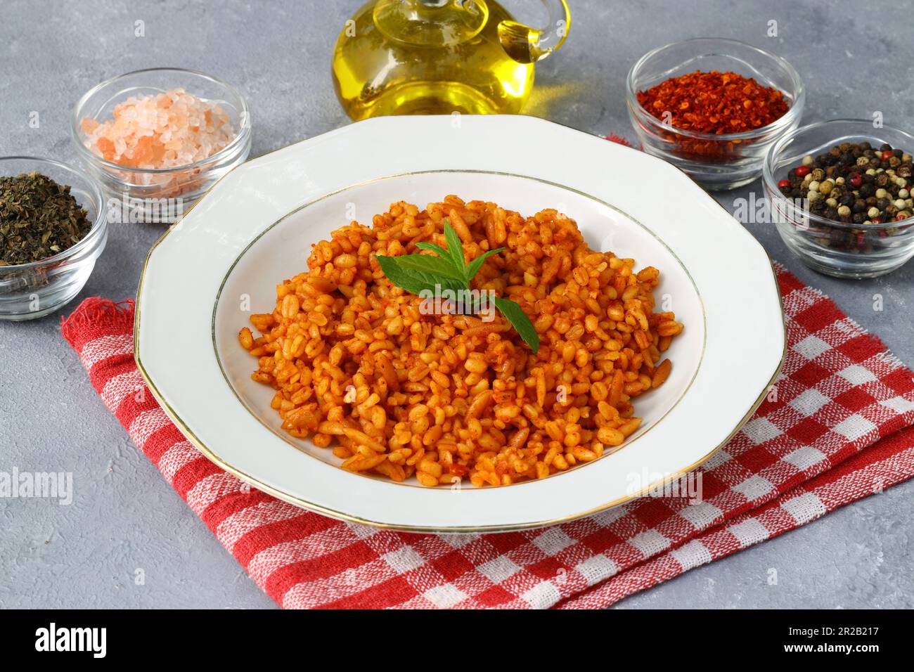Traditional turkish bulgur pilaf with tomato sause in plate (Turkish ...