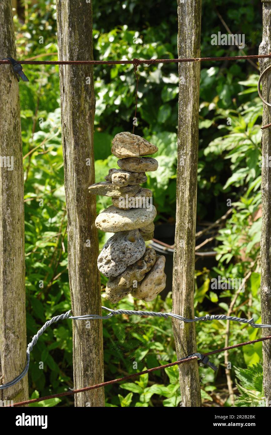 Stones hanging on garden fence Stock Photo - Alamy