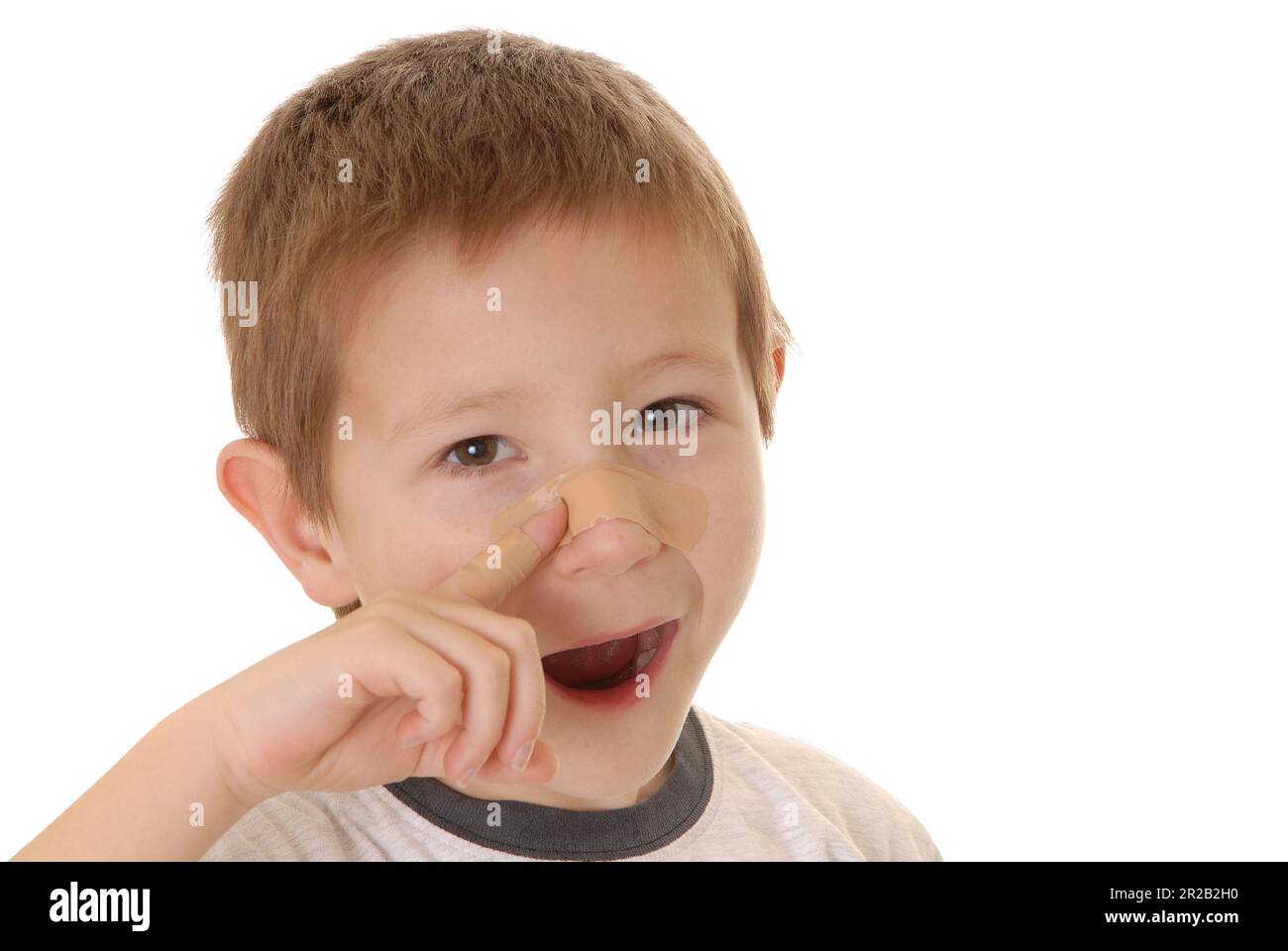 Young boy with an injury covered by a band-aid Stock Photo - Alamy