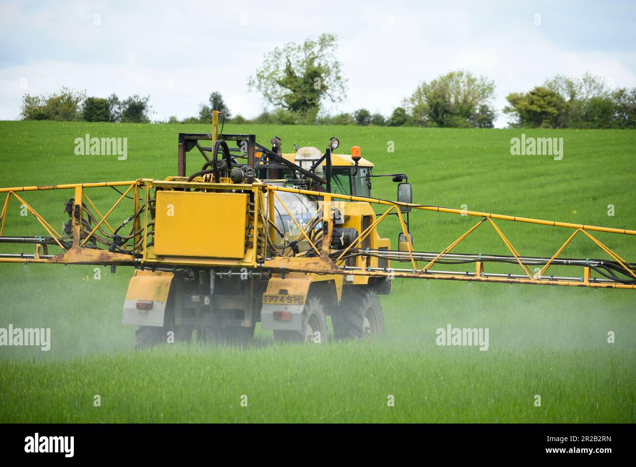 Spraying spring Barley in Dorset field with a boom sprayer Stock Photo ...