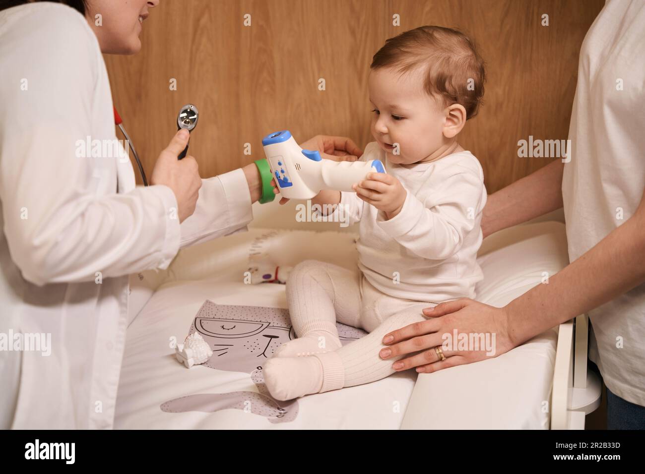 ENT doctor examining child under parental supervision Stock Photo - Alamy