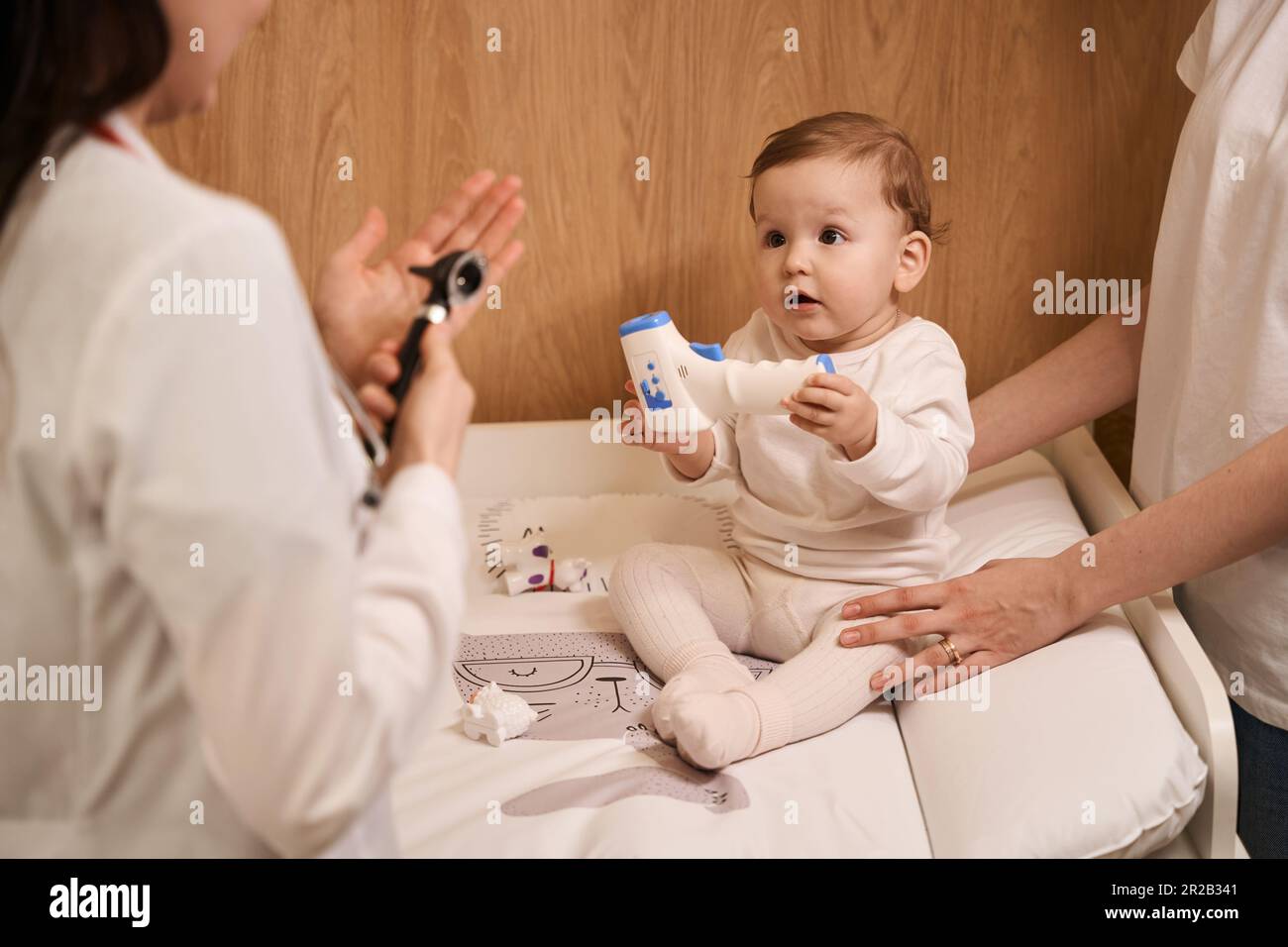 Baby being examined by otolaryngologist in presence of mother Stock ...
