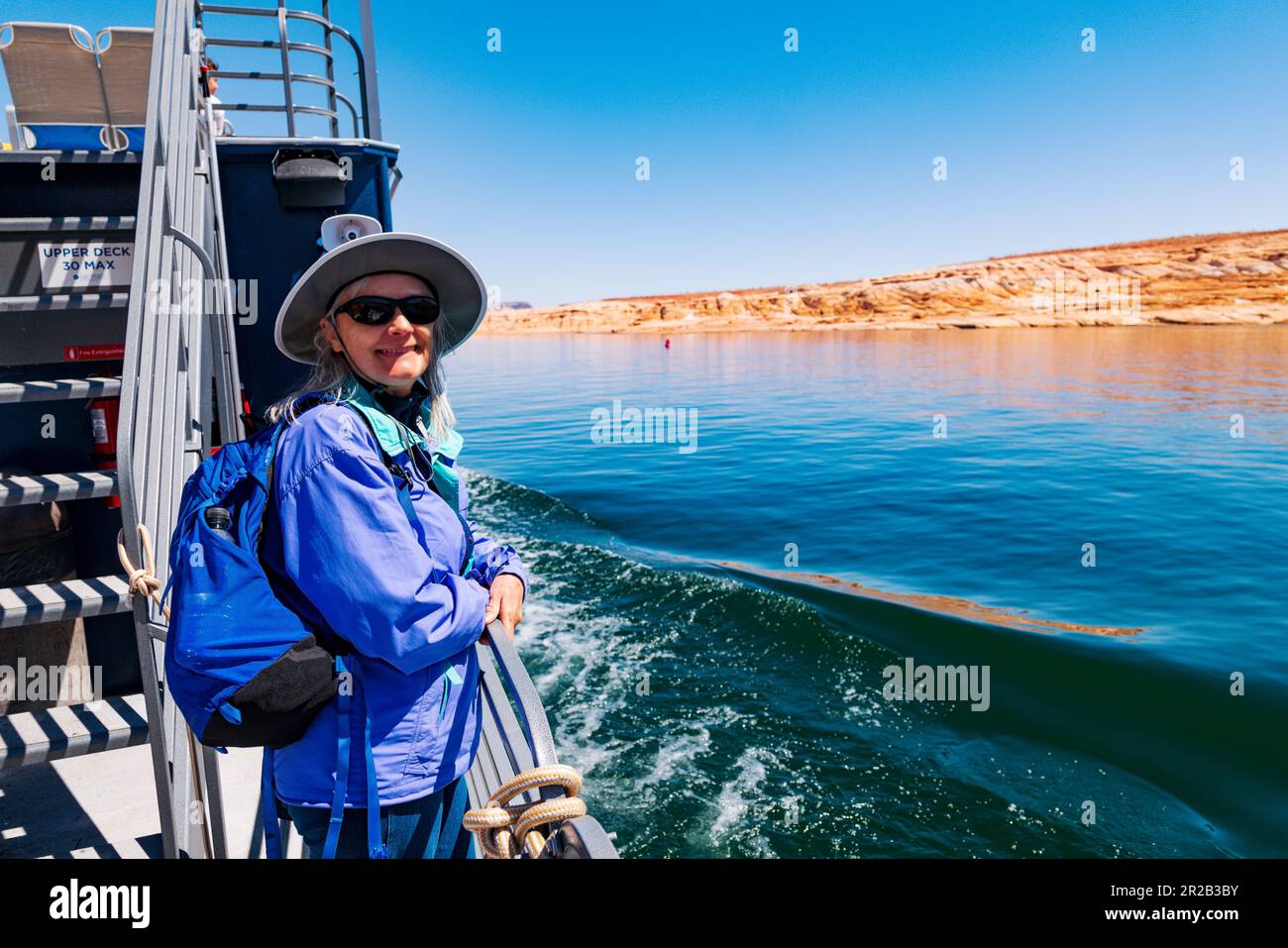 Senior female tourist enjoying boat tour; Lake Powell; Glen Canyon Dam ...