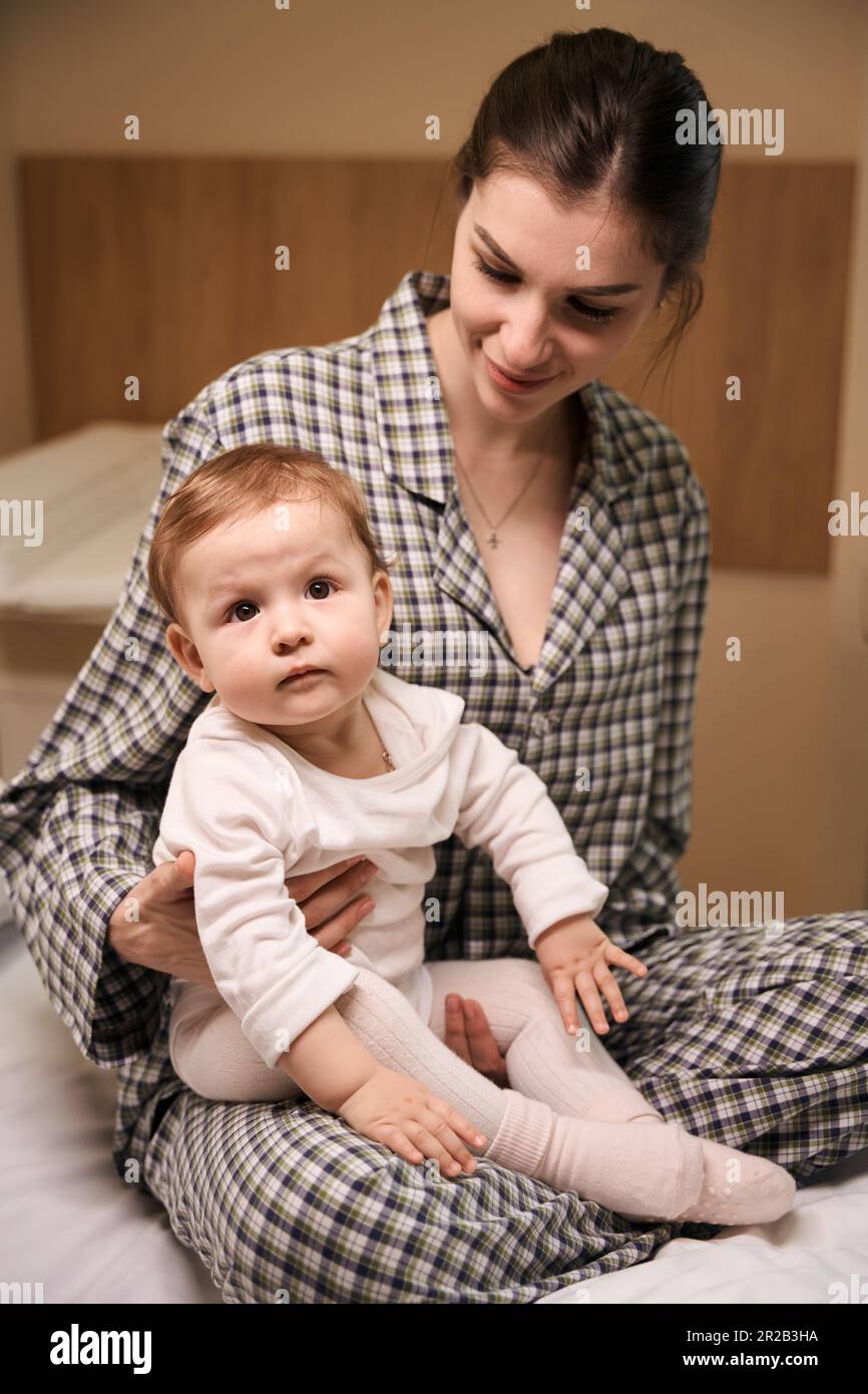 Caring mom staying with ill child in pediatric hospital Stock Photo - Alamy