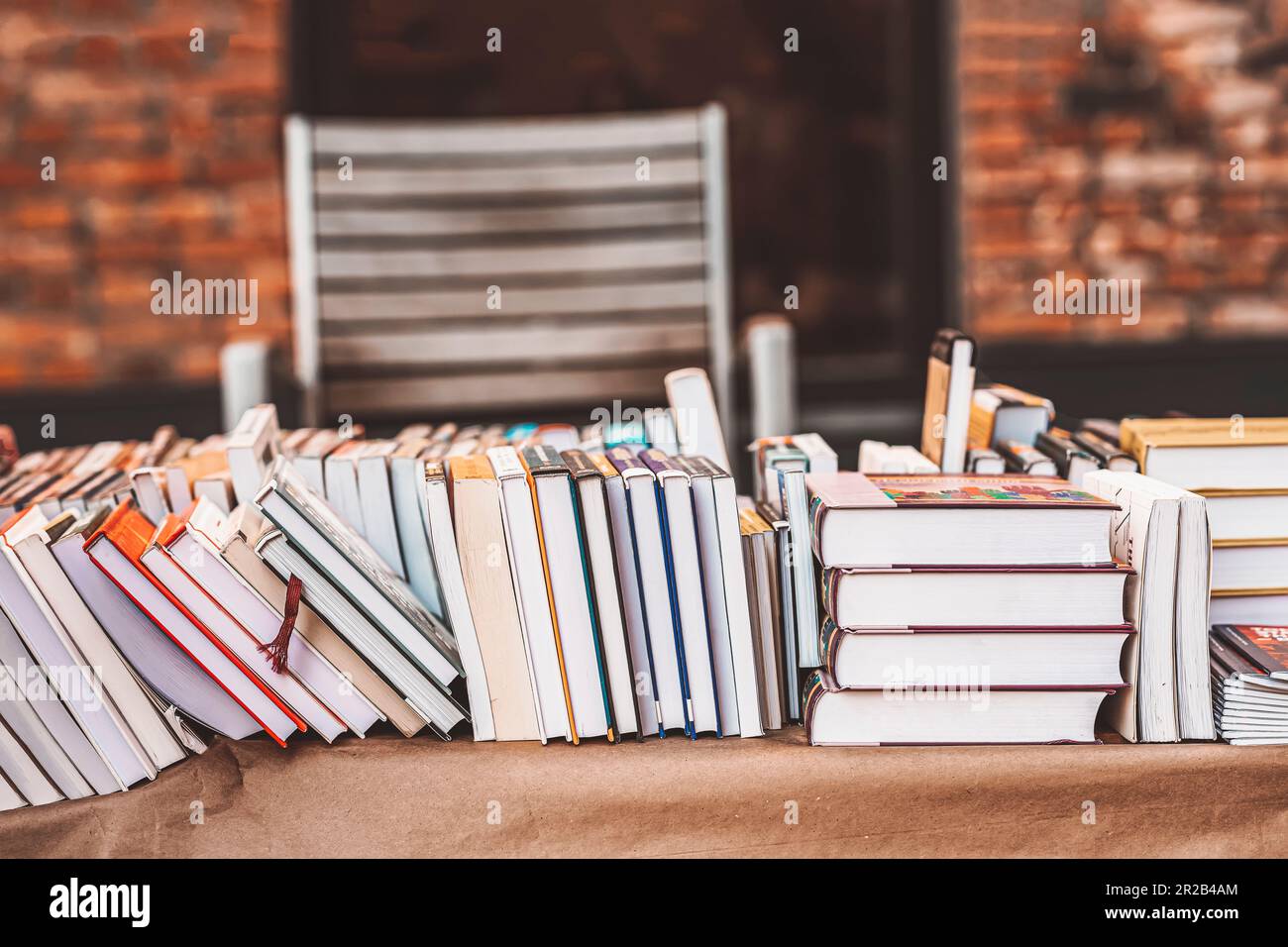 Pile of books on table outdoor. Abstract blurred background, selective ...