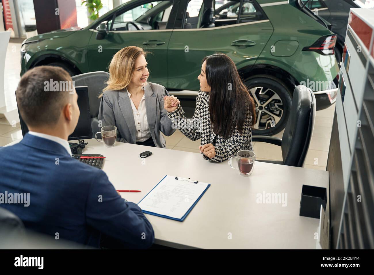 Car dealership manager making car purchase for happy lgbt couple Stock ...