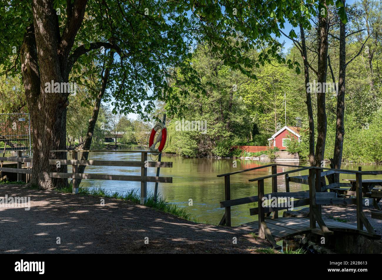 View acrooss Motala river from waterfront park Åbackarna towards ...