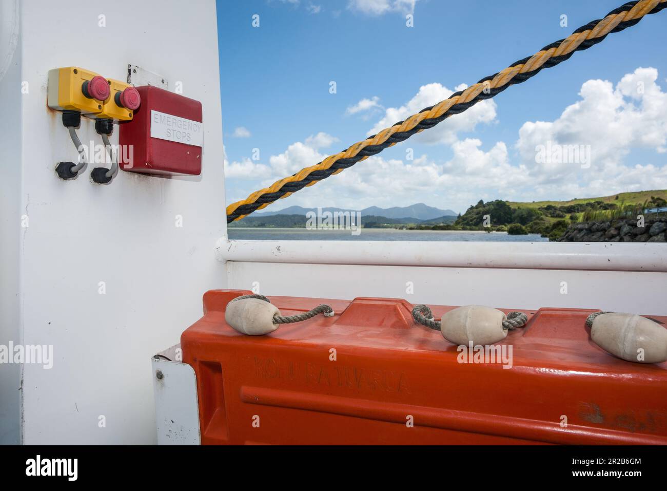 Diagonal yellow and black mooring rope leading to emergency stop ...