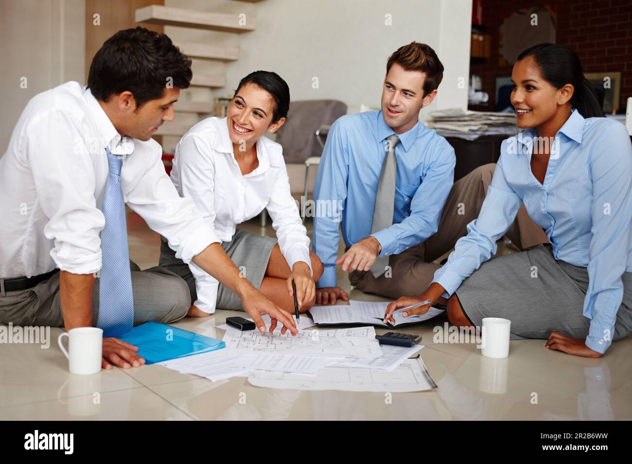 Changing their work routine up a bit. Four business colleagues going ...