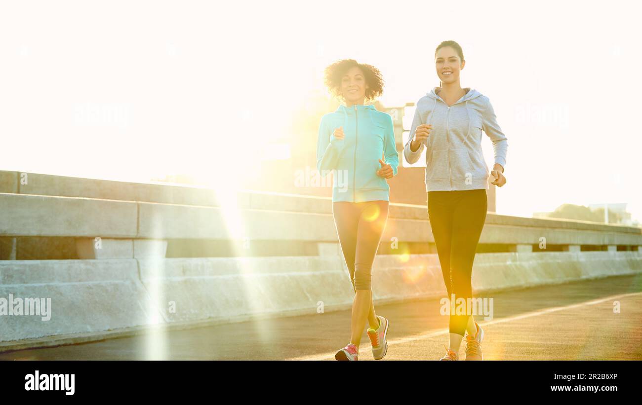 Its a glorious morning for a run. two friends jogging together in the ...