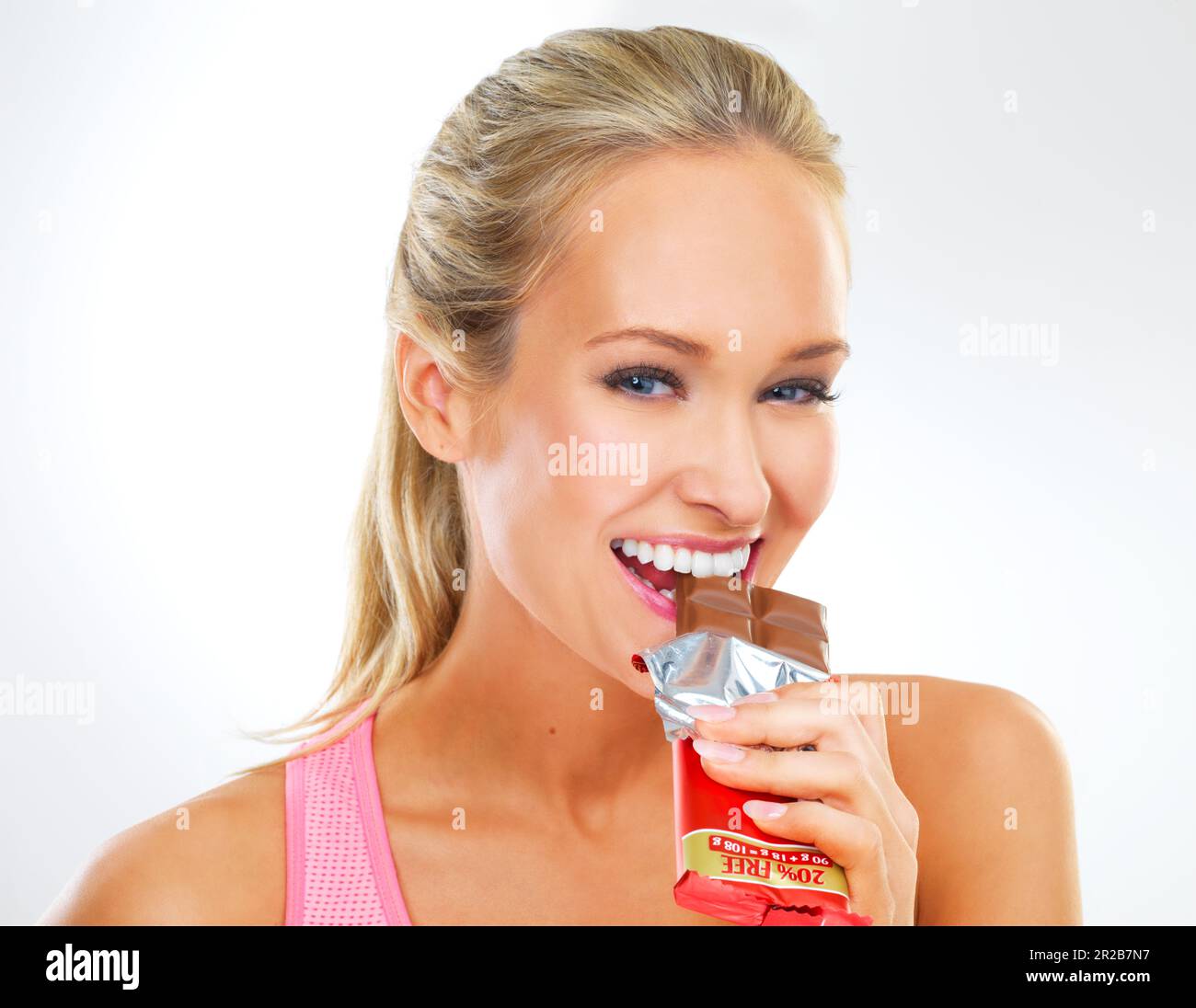 Everything in moderation. fit young woman in exercise clothes eating a ...